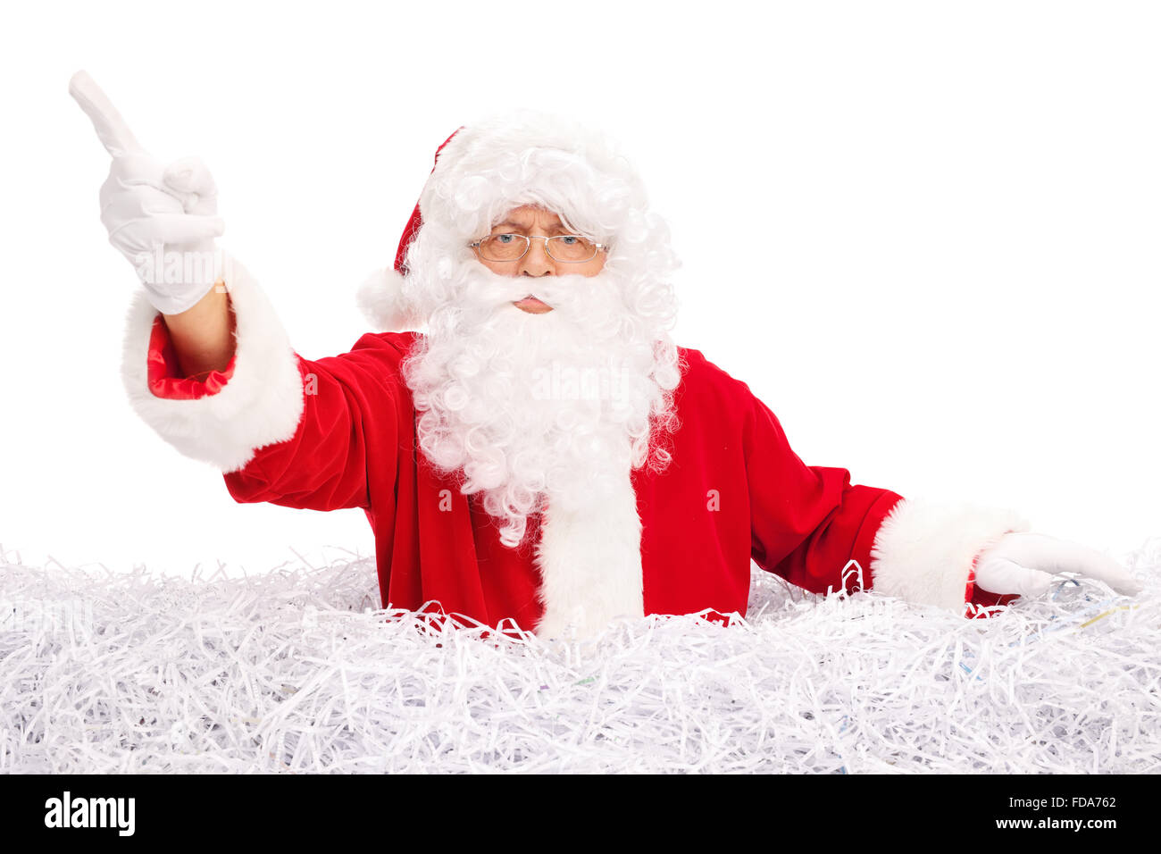 Angry Santa Claus pointing with his finger and standing in a pile of ...