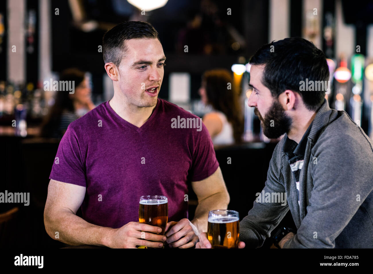 Friends interacting having drink 4k hi-res stock photography and images ...