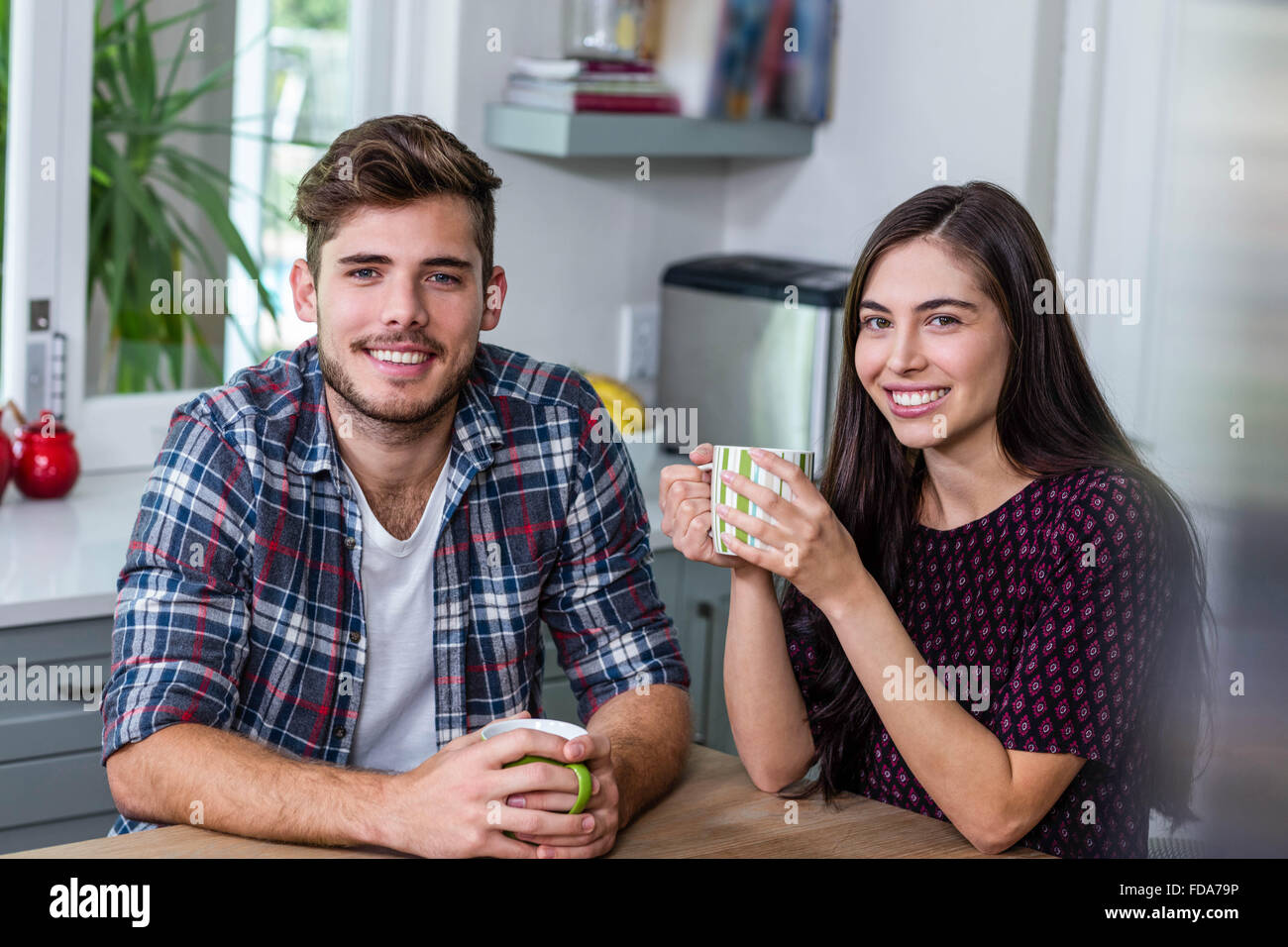Happy couple having coffee together Stock Photo - Alamy