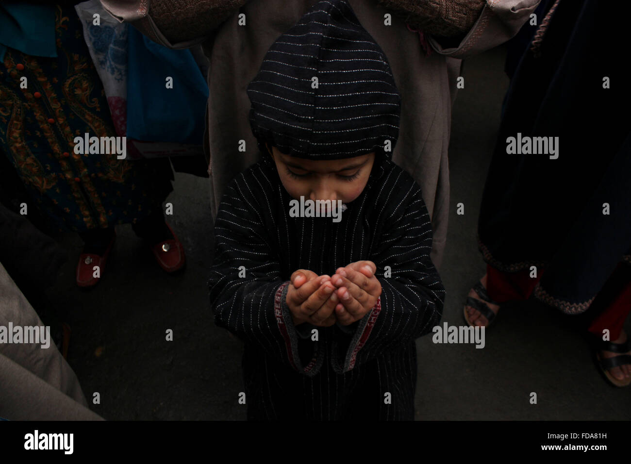 A kashmiri muslim boy praying amid with devotees praying on the annual ...