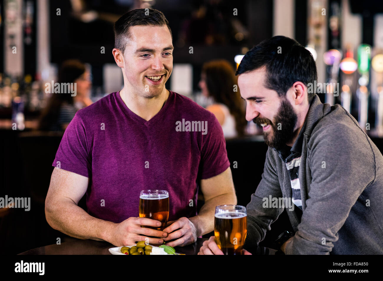 Friends having a pint Stock Photo - Alamy