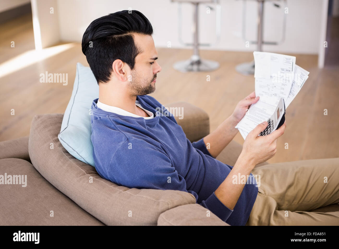Serious man checking receipts Stock Photo - Alamy