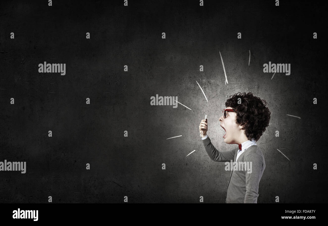 Funny young man with big head screaming emotional in mobile phone Stock ...