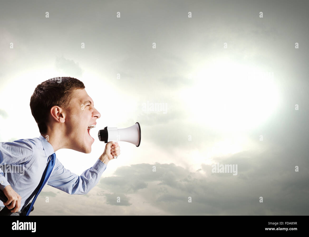 Funny young man with big head screaming emotionally in megaphone Stock ...