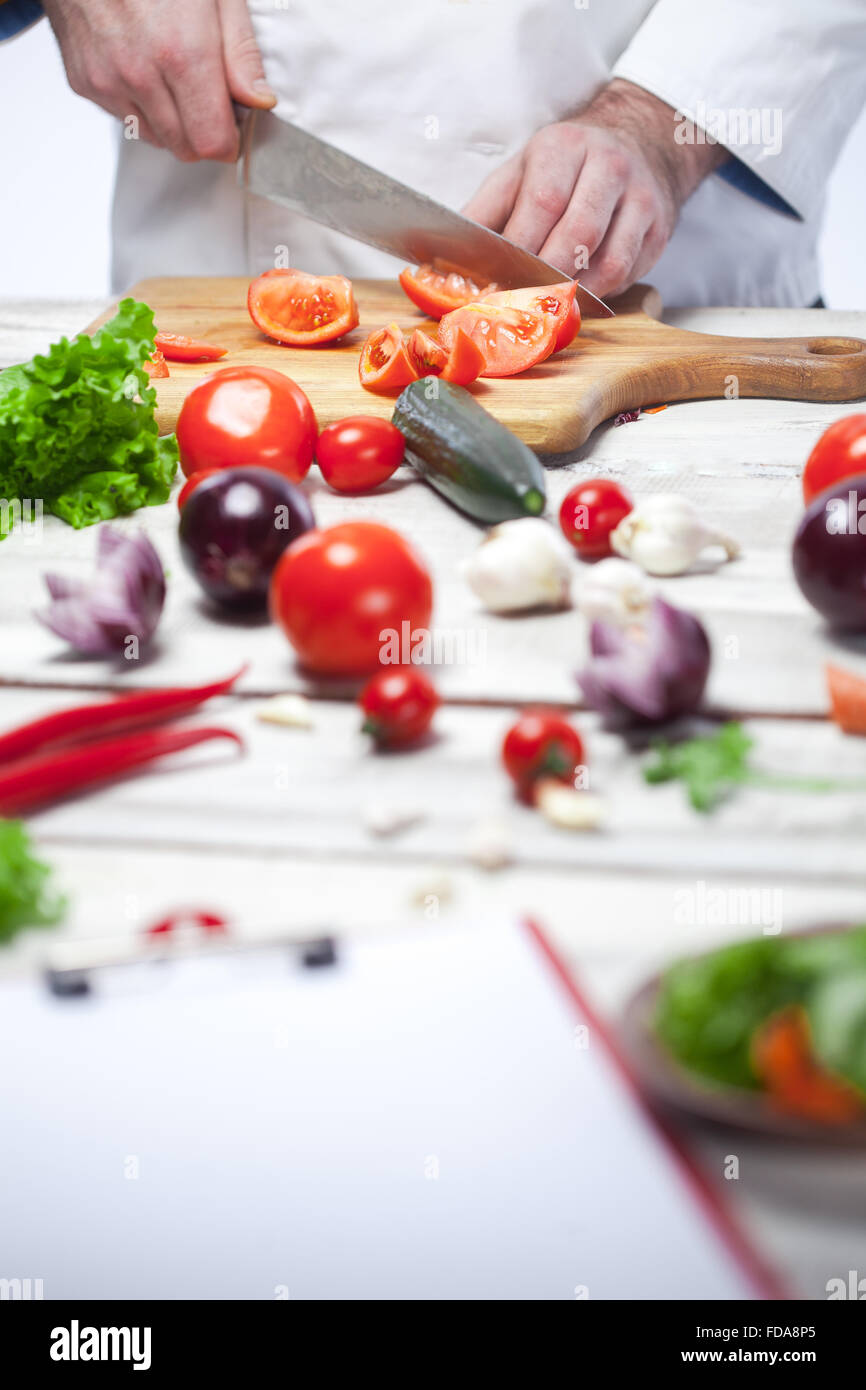 Male chef hand cutting tomato hi-res stock photography and images - Alamy