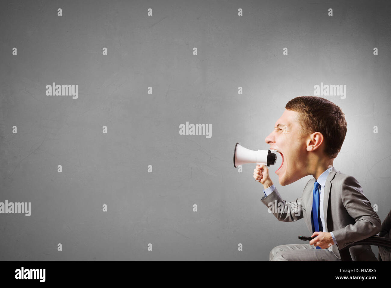 Funny young man with big head screaming emotionally in megaphone Stock ...