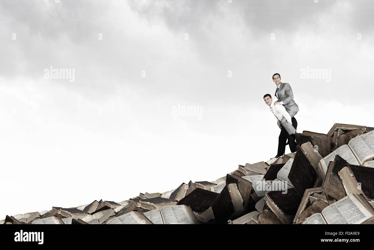 Businessman riding on back of his colleague Stock Photo - Alamy