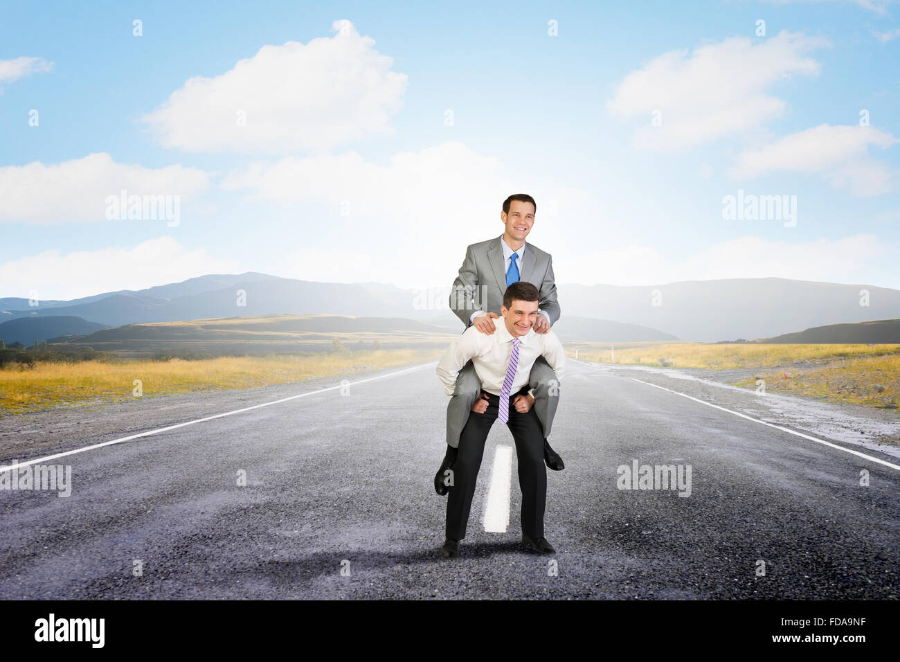 Businessman riding on back of his colleague Stock Photo - Alamy