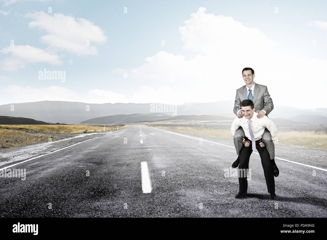 Businessman riding on back of his colleague Stock Photo - Alamy