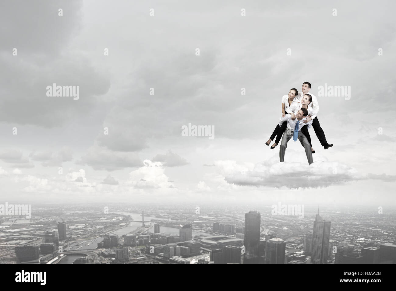 Businesspeople riding on back of their colleague Stock Photo - Alamy
