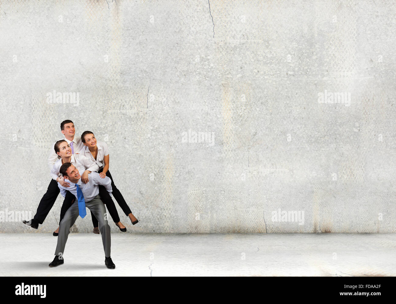 Businesspeople riding on back of their colleague Stock Photo - Alamy