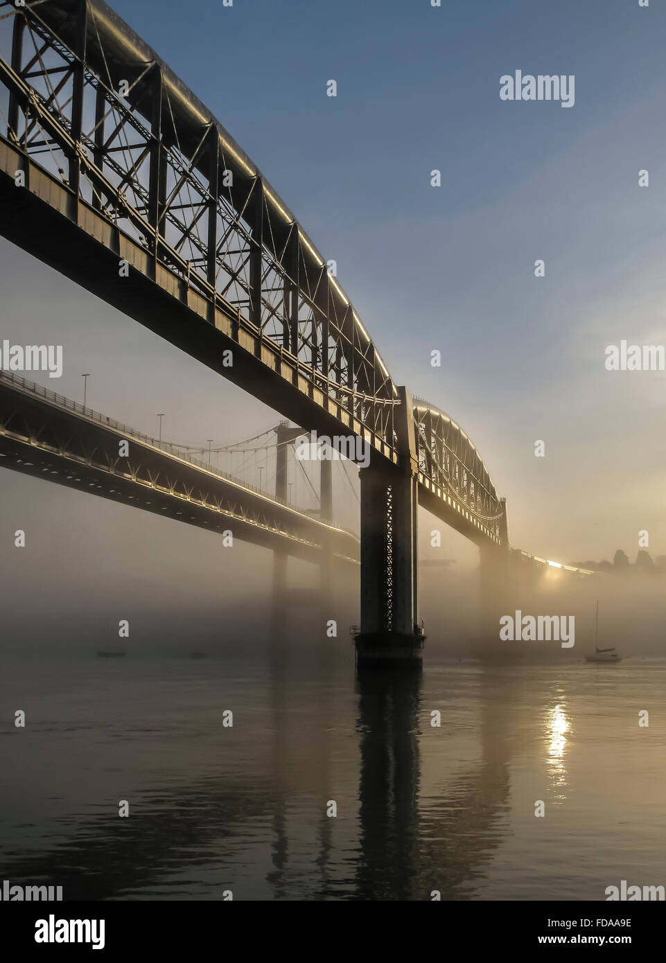 Sun reflecting on Tamar Bridges in Mist, cornwall Stock Photo - Alamy