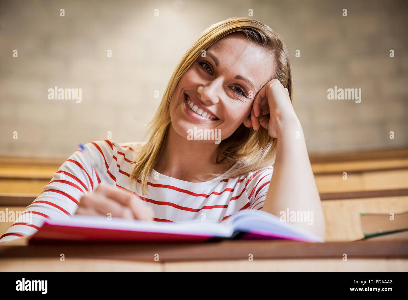 Female student taking notes in a class Stock Photo - Alamy