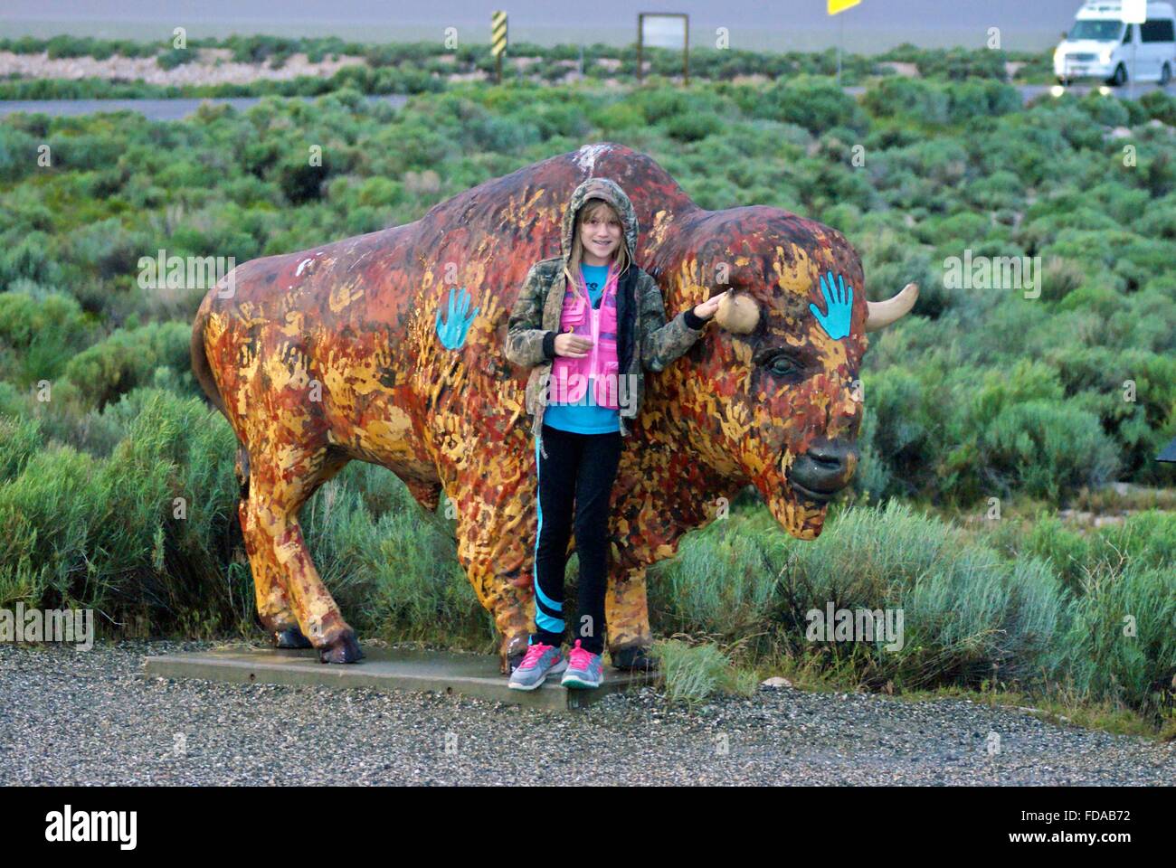 Little girl standing by a colorful bison statue on Antelope Island in ...