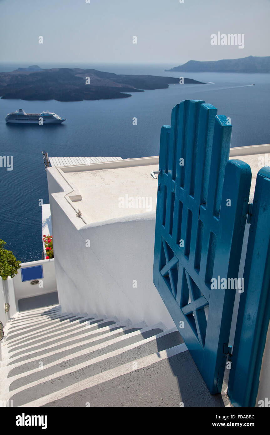 Traditional rooftop gate leading to a view of the Caldera on the greek ...