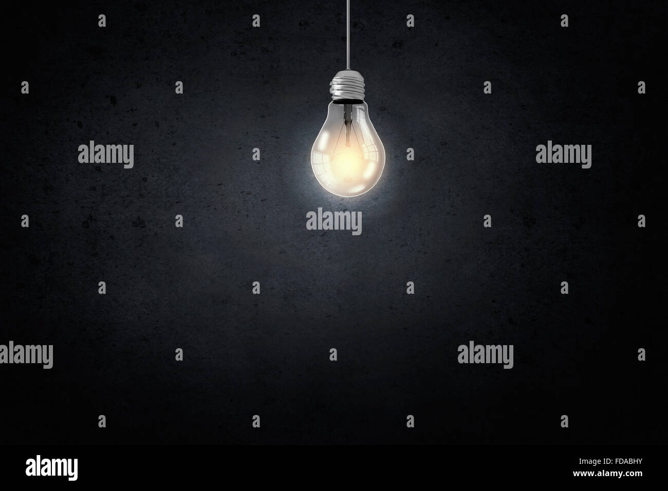 Glowing light bulb on dark background hanging from above Stock Photo ...