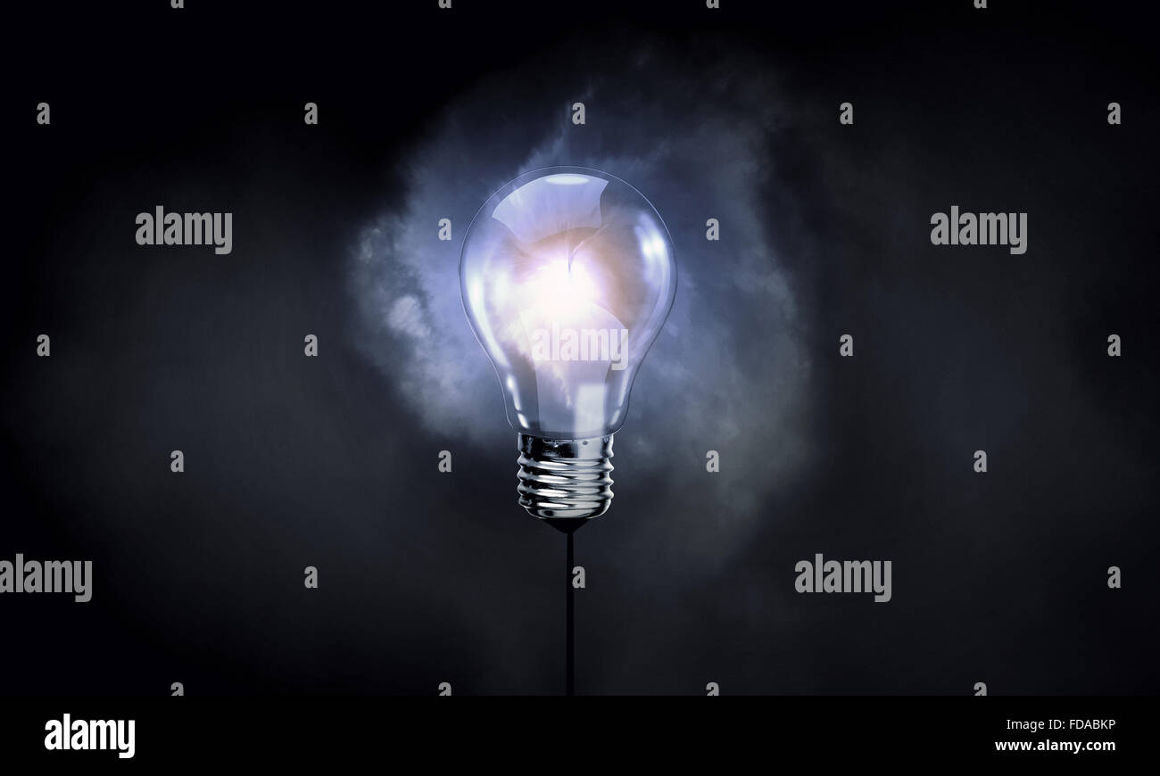 Glowing inverted light bulb on dark background Stock Photo - Alamy