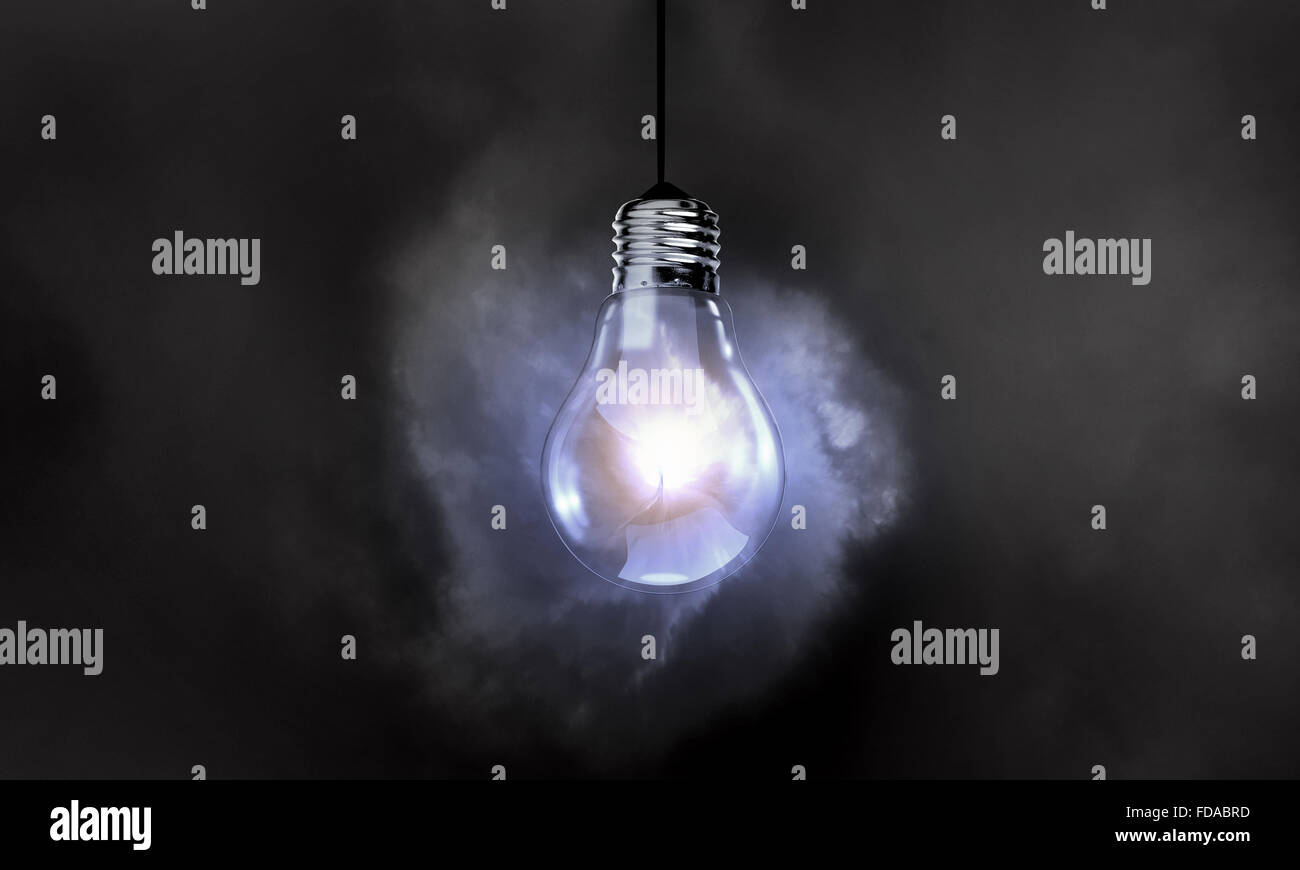 Glowing light bulb on dark background hanging from above Stock Photo ...