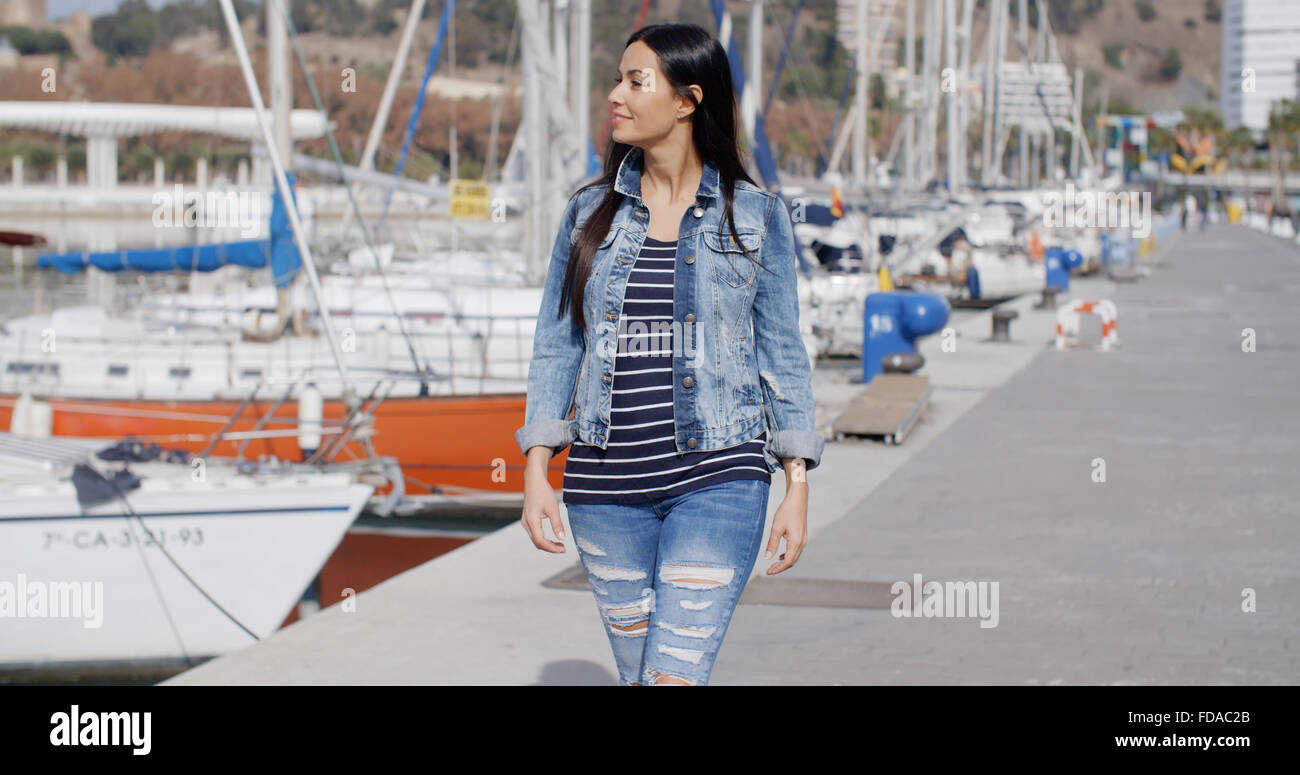 Pretty woman strolling on a waterfront promenade Stock Photo - Alamy