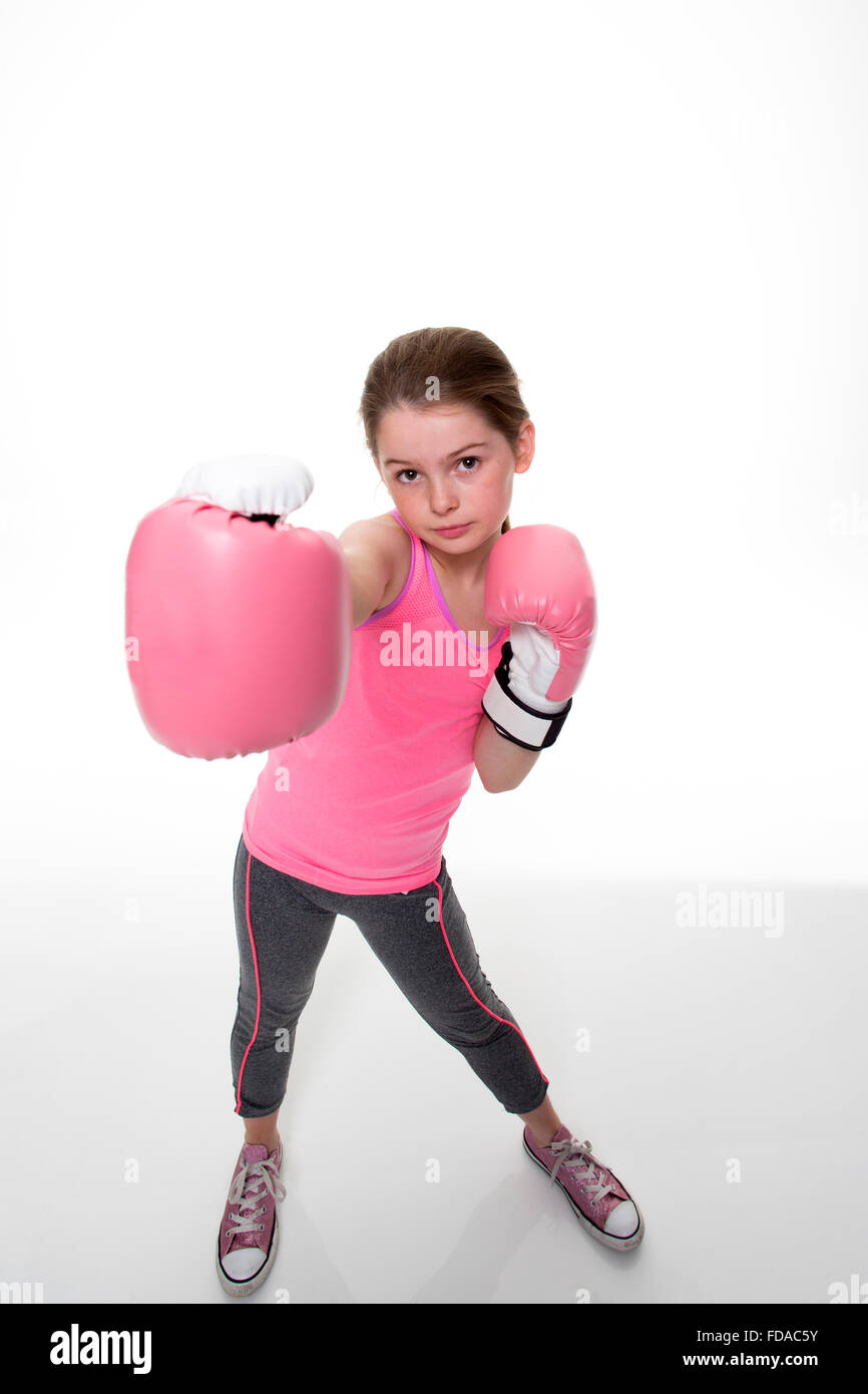 Portrait of a young girl learning to box. She is looking at the camera ...