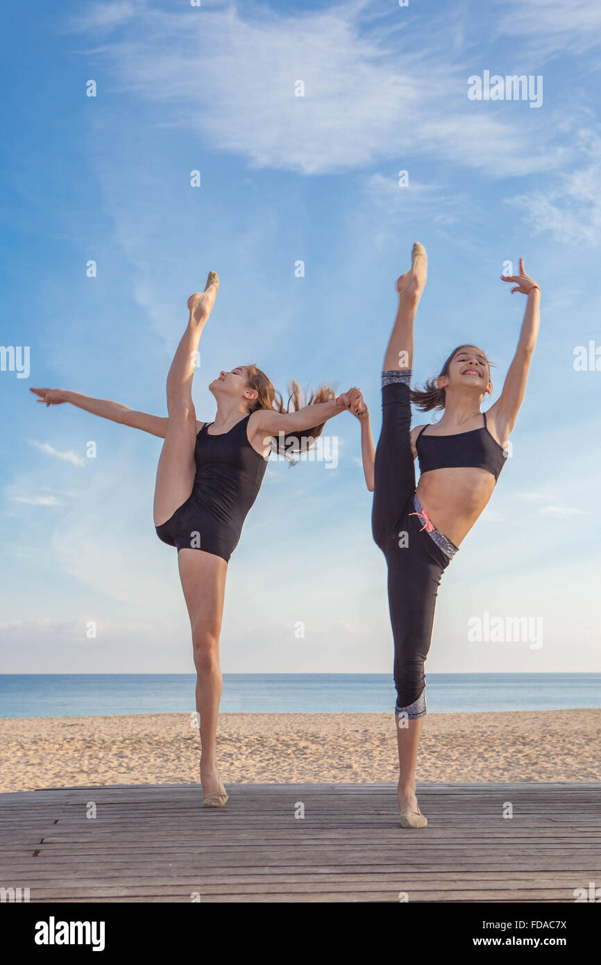 gymnasts exercising sports pose Stock Photo - Alamy