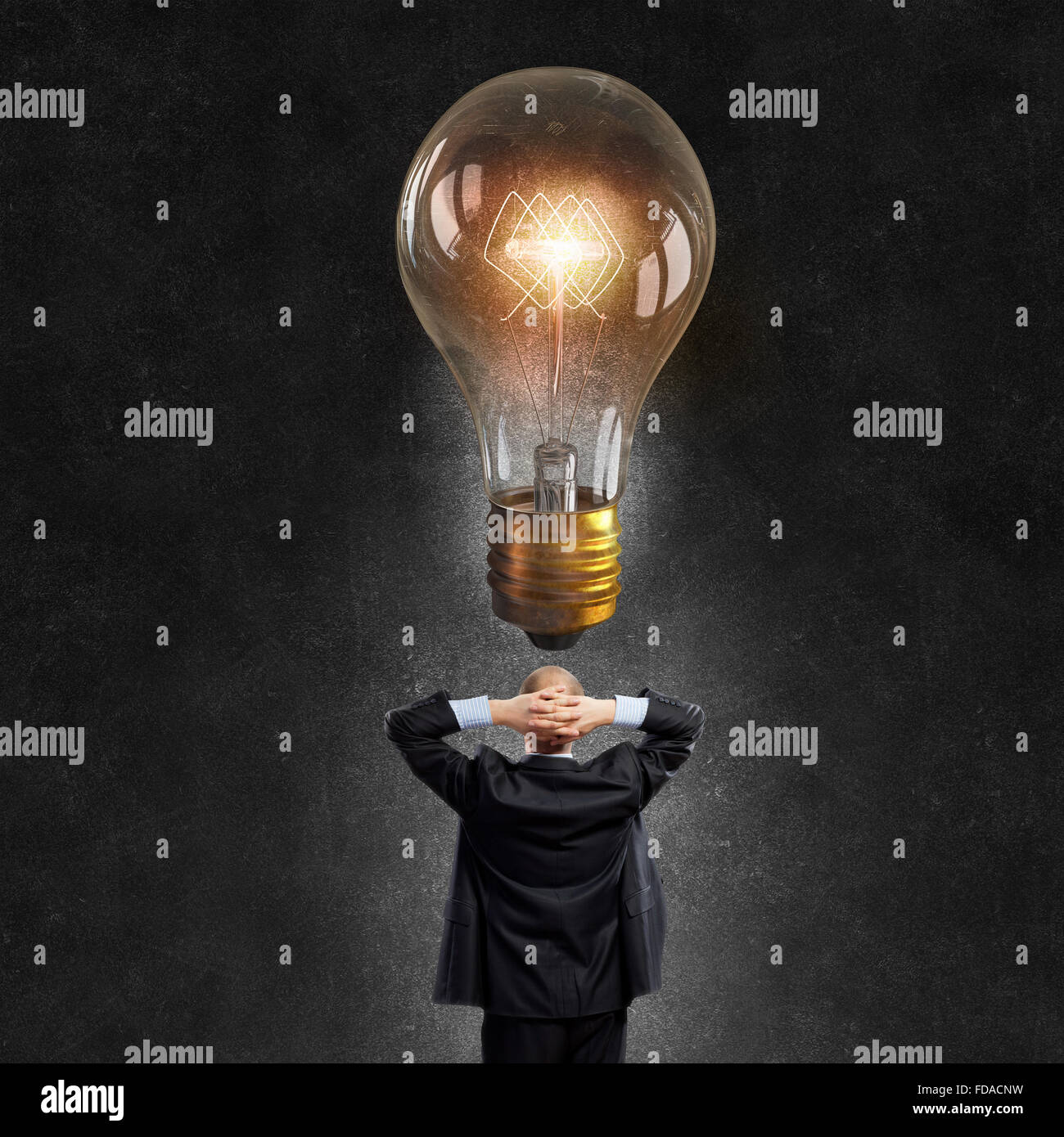 Young businessman and glass glowing light bulb above his head Stock ...