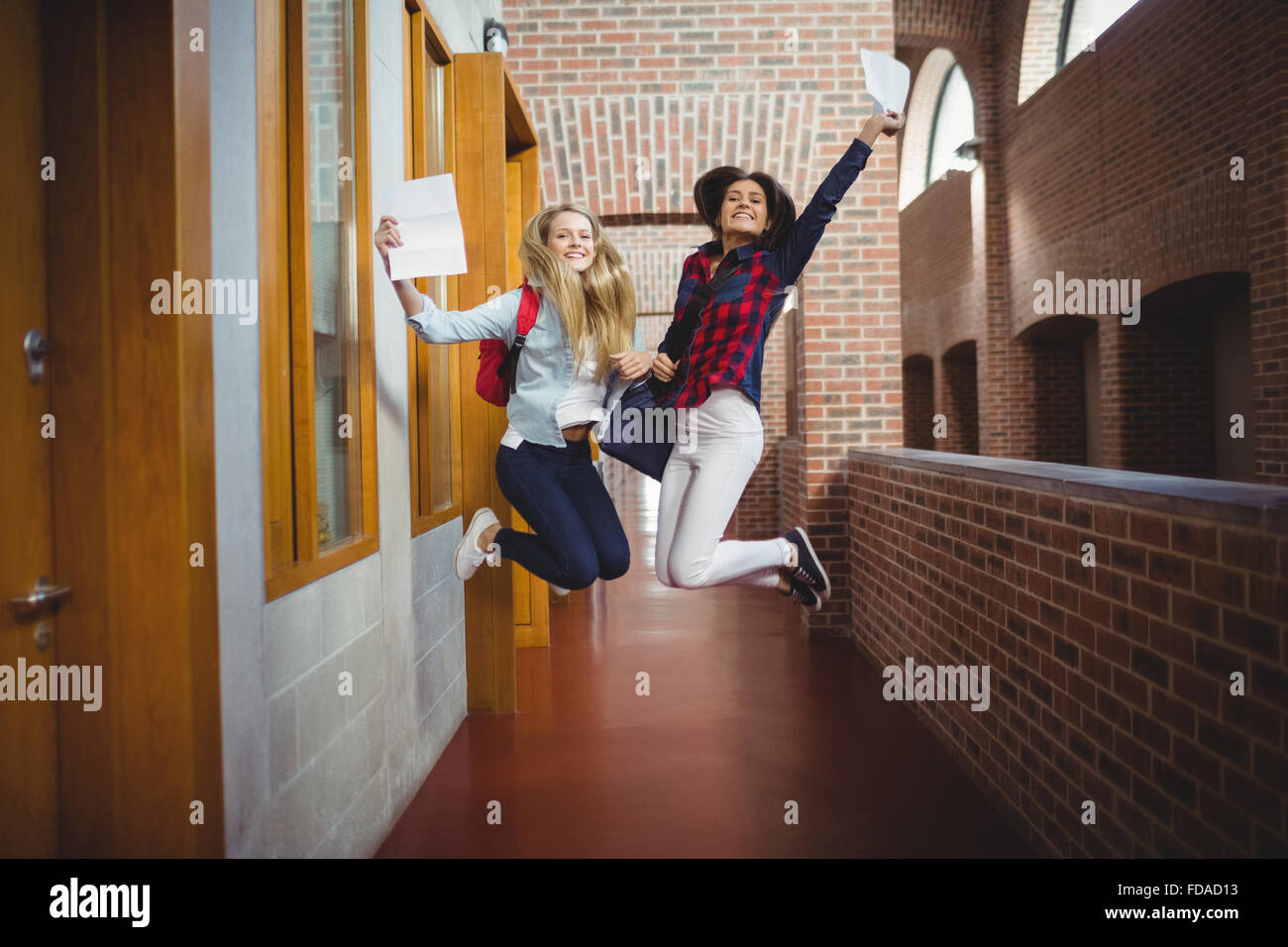 Happy female students receiving results Stock Photo - Alamy