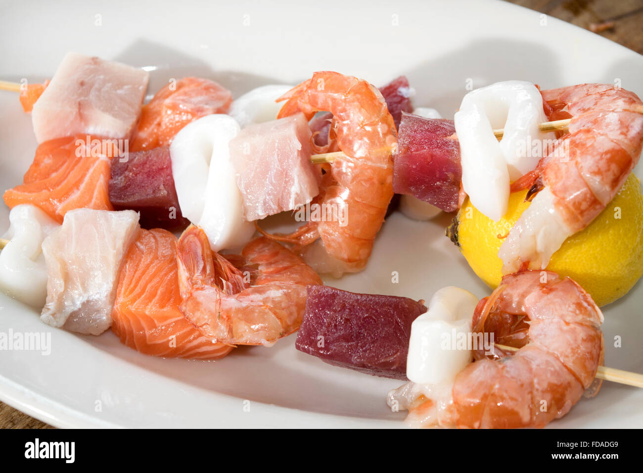 fish skewers with tuna salmon squids and prawns Stock Photo - Alamy