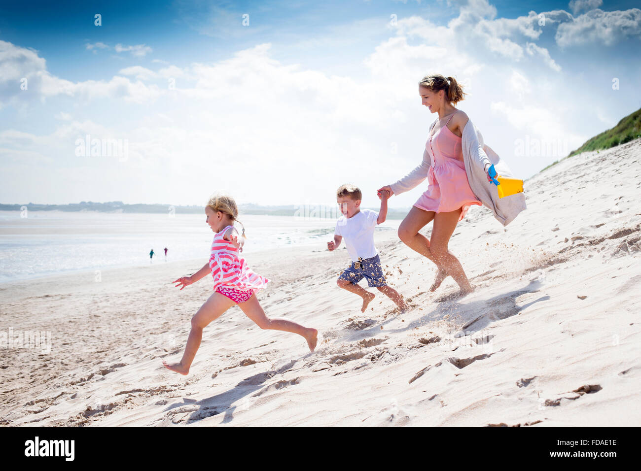 Two children holding hands running down hi-res stock photography and ...