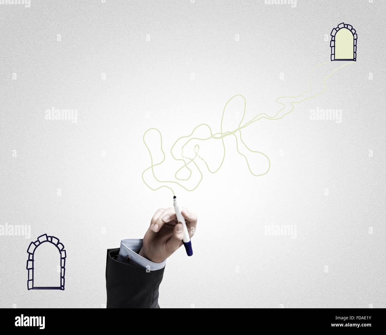 Close up of male hand drawing twisted way from one door to another ...