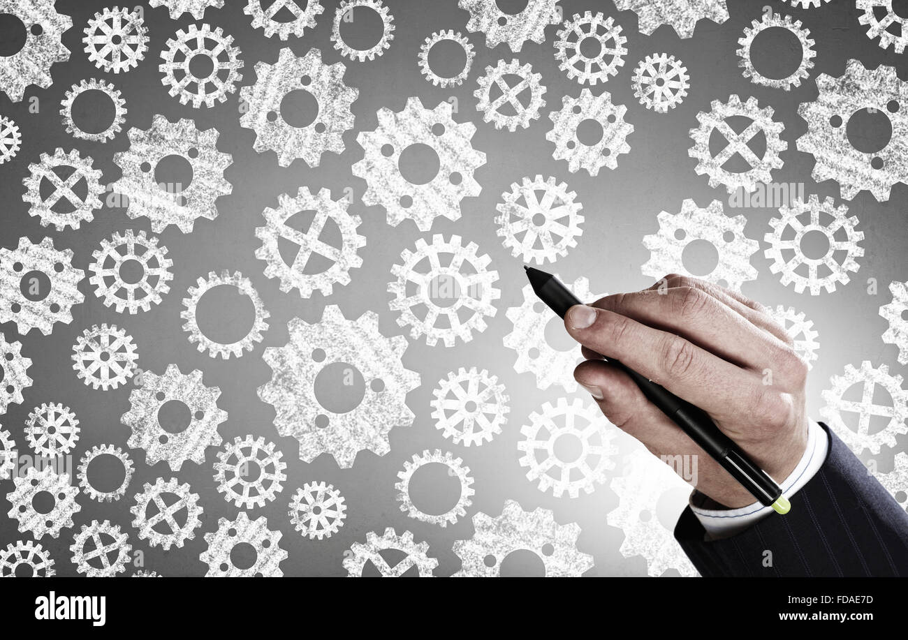 Close up of hand drawing gears mechanism with marker Stock Photo - Alamy