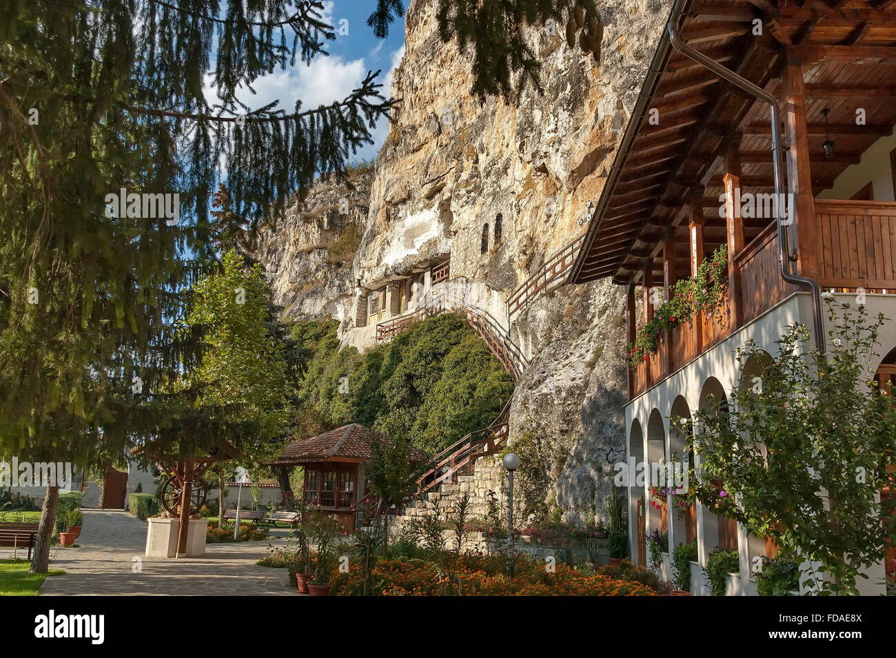 Yard of the rock monastery "St Dimitrii of Basarbovo" with draw-well ...
