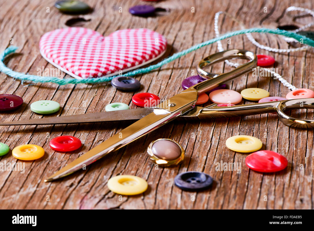 a heart made with a red and white checkered fabric, a pair of scissors ...