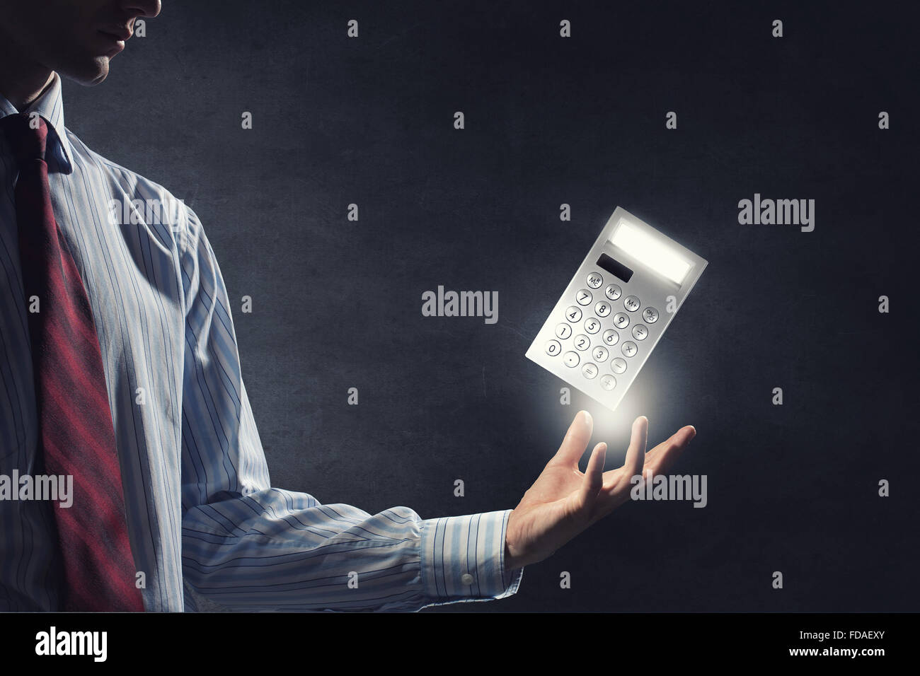 Close up of male hand holding calculator Stock Photo - Alamy