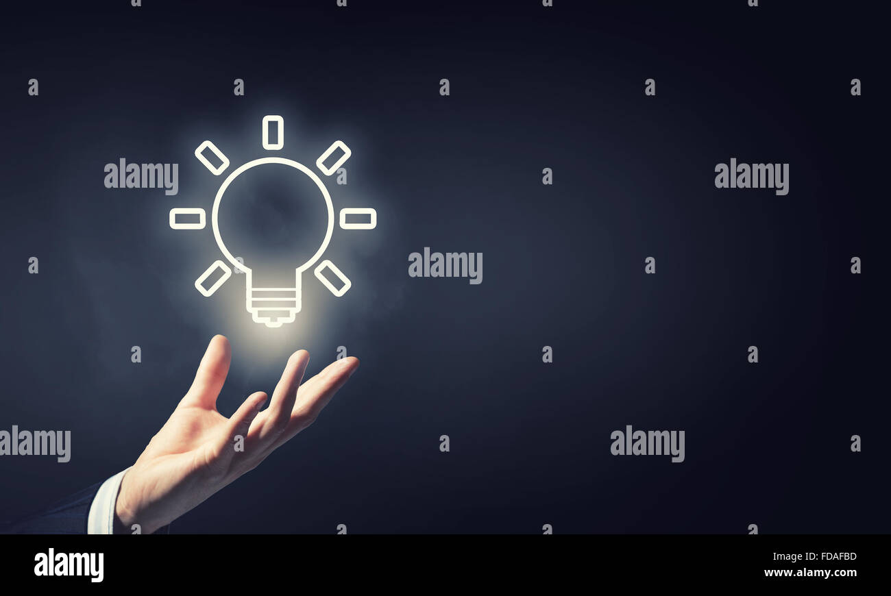 Close up of hand holding light bulb in palm Stock Photo - Alamy