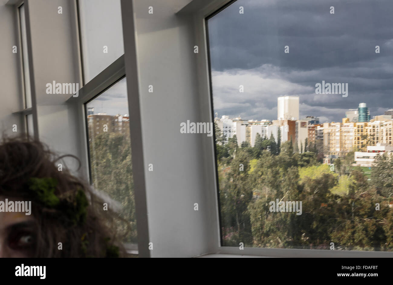 An actor looking by a window building Stock Photo - Alamy