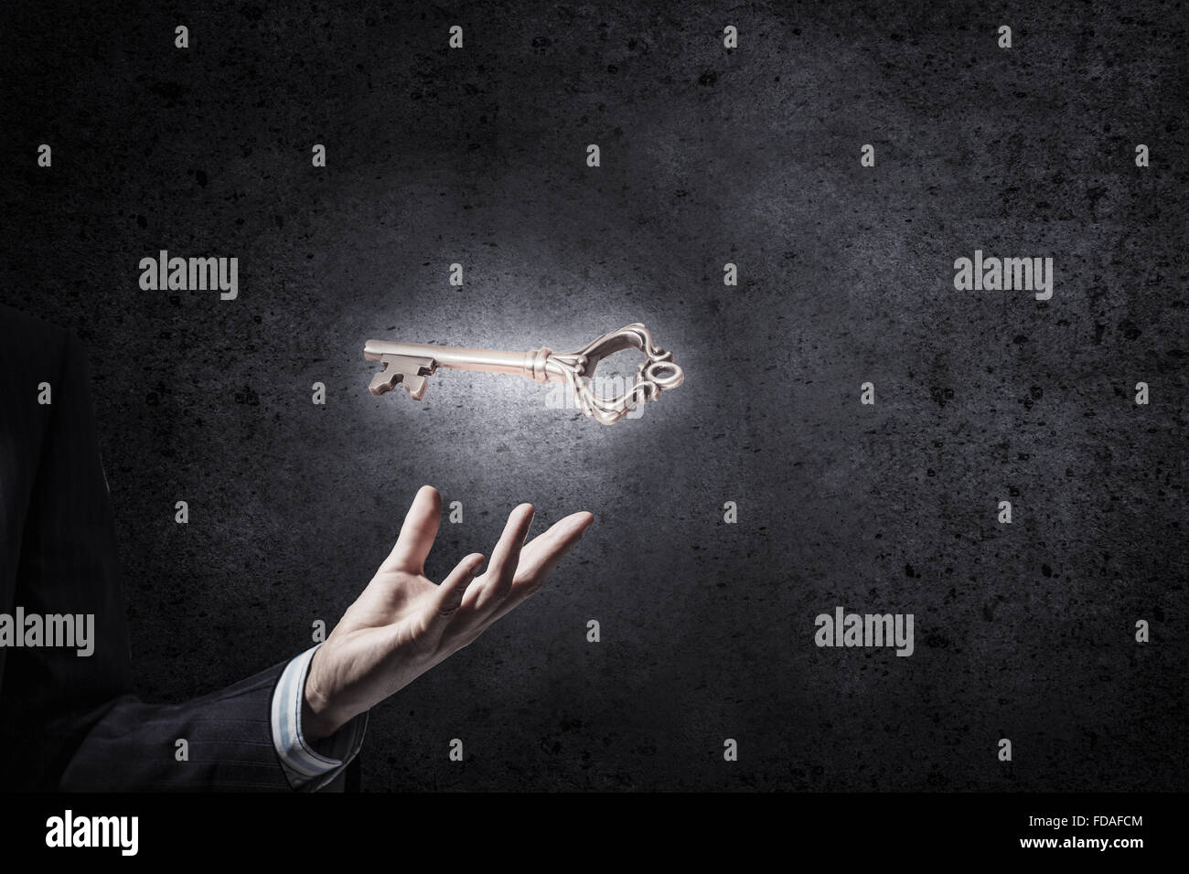 Close up of human hand holding key symbol Stock Photo - Alamy