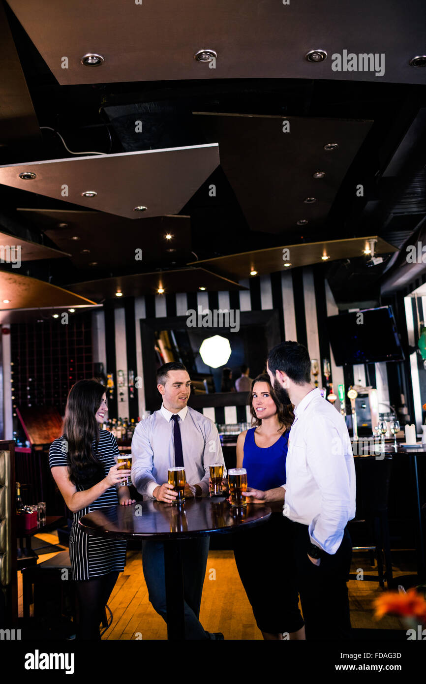 Friends talking and having a beer Stock Photo - Alamy