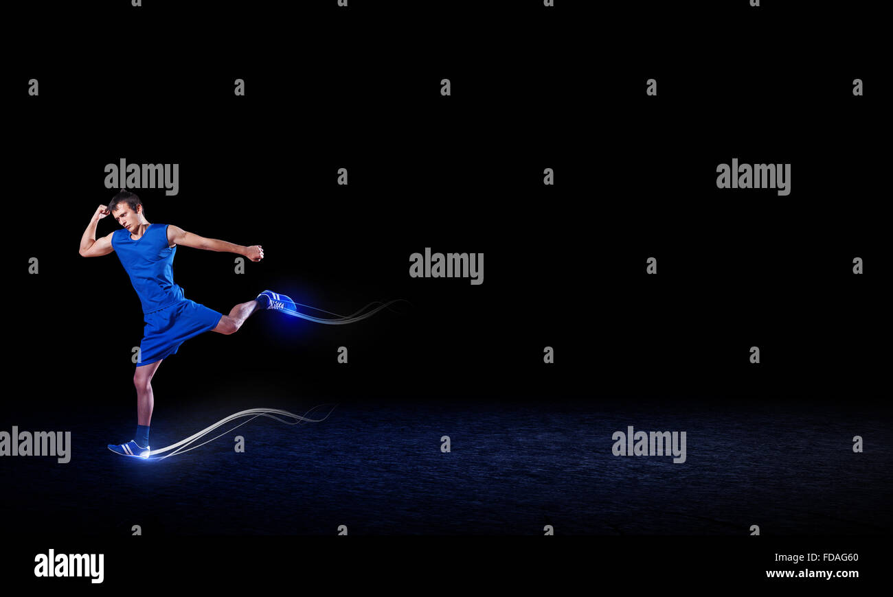 Running man in blue sport wear on black background Stock Photo - Alamy
