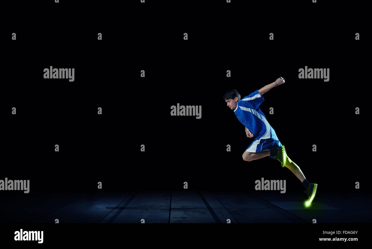 Running man in blue sport wear on black background Stock Photo - Alamy