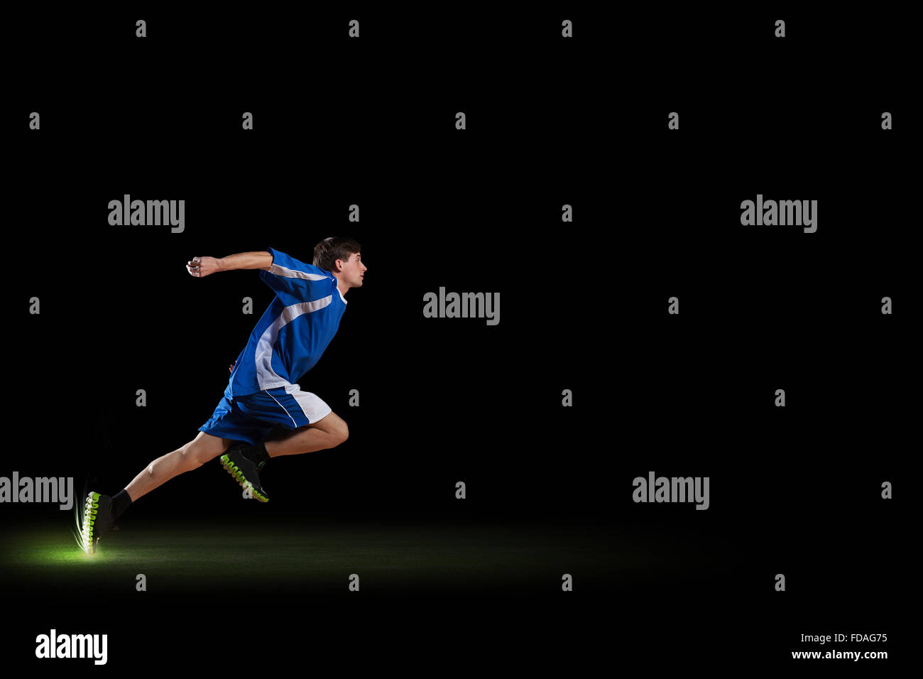 Running man in blue sport wear on black background Stock Photo - Alamy