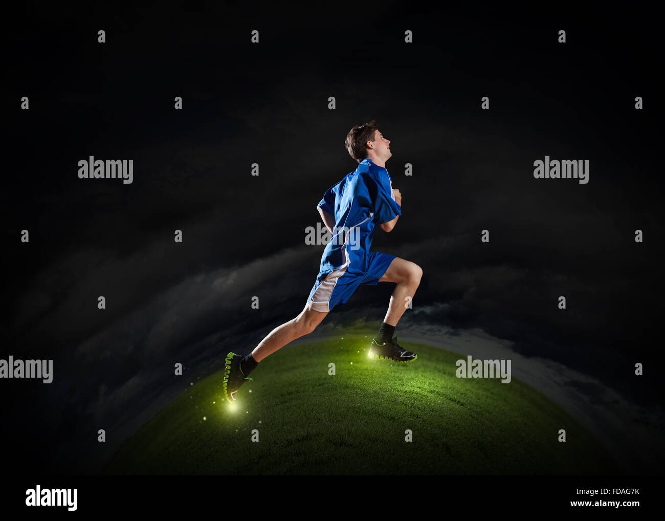 Running man in blue sport wear on black background Stock Photo - Alamy