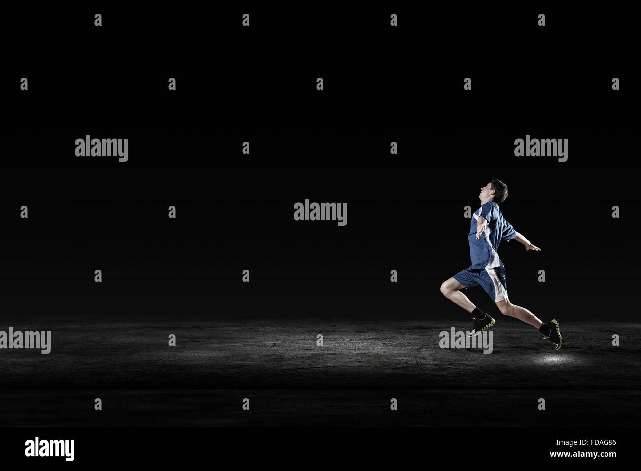 Running man in blue sport wear on black background Stock Photo - Alamy