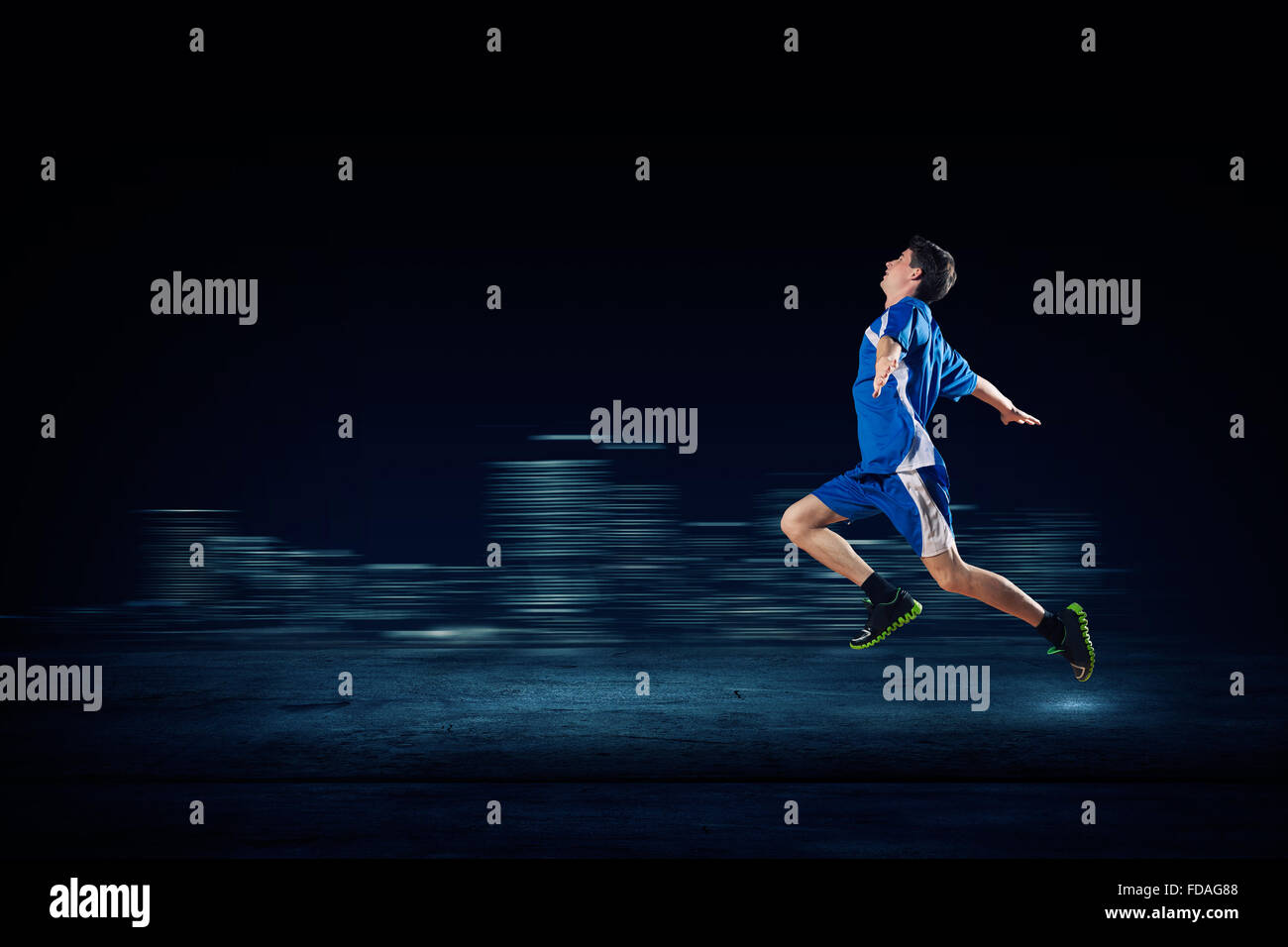 Running man in blue sport wear on black background Stock Photo - Alamy