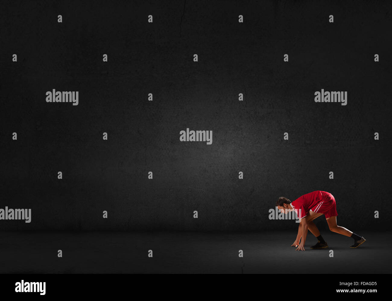 Running man in red sport wear on dark background Stock Photo - Alamy