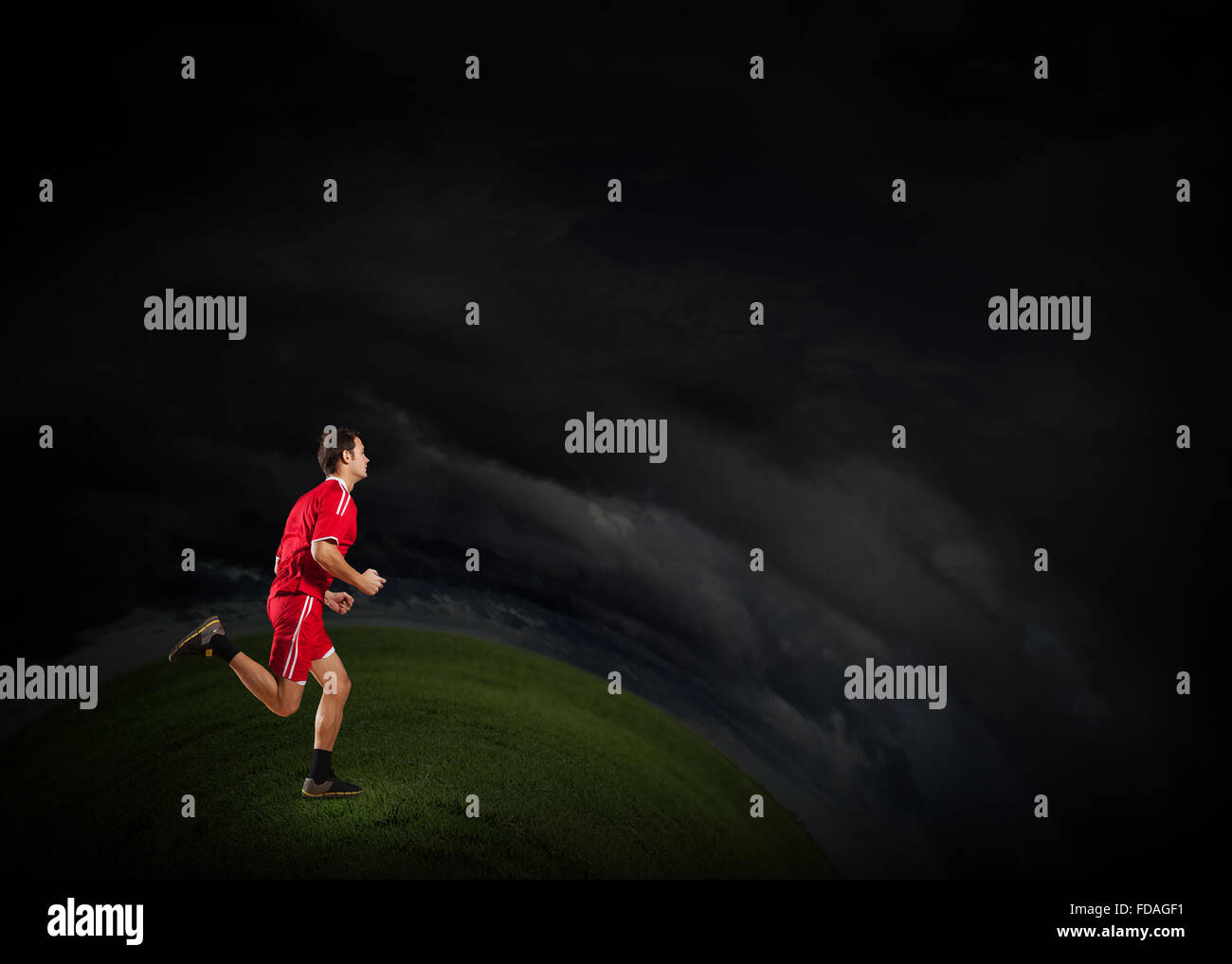 Running man in red sport wear on dark background Stock Photo - Alamy