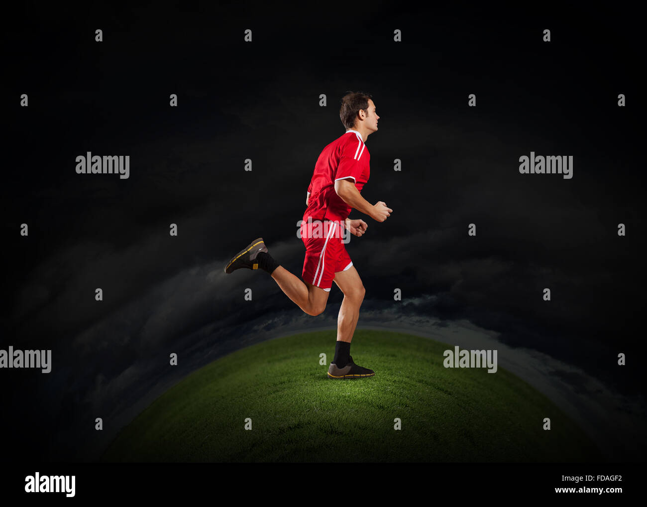Running man in red sport wear on dark background Stock Photo - Alamy