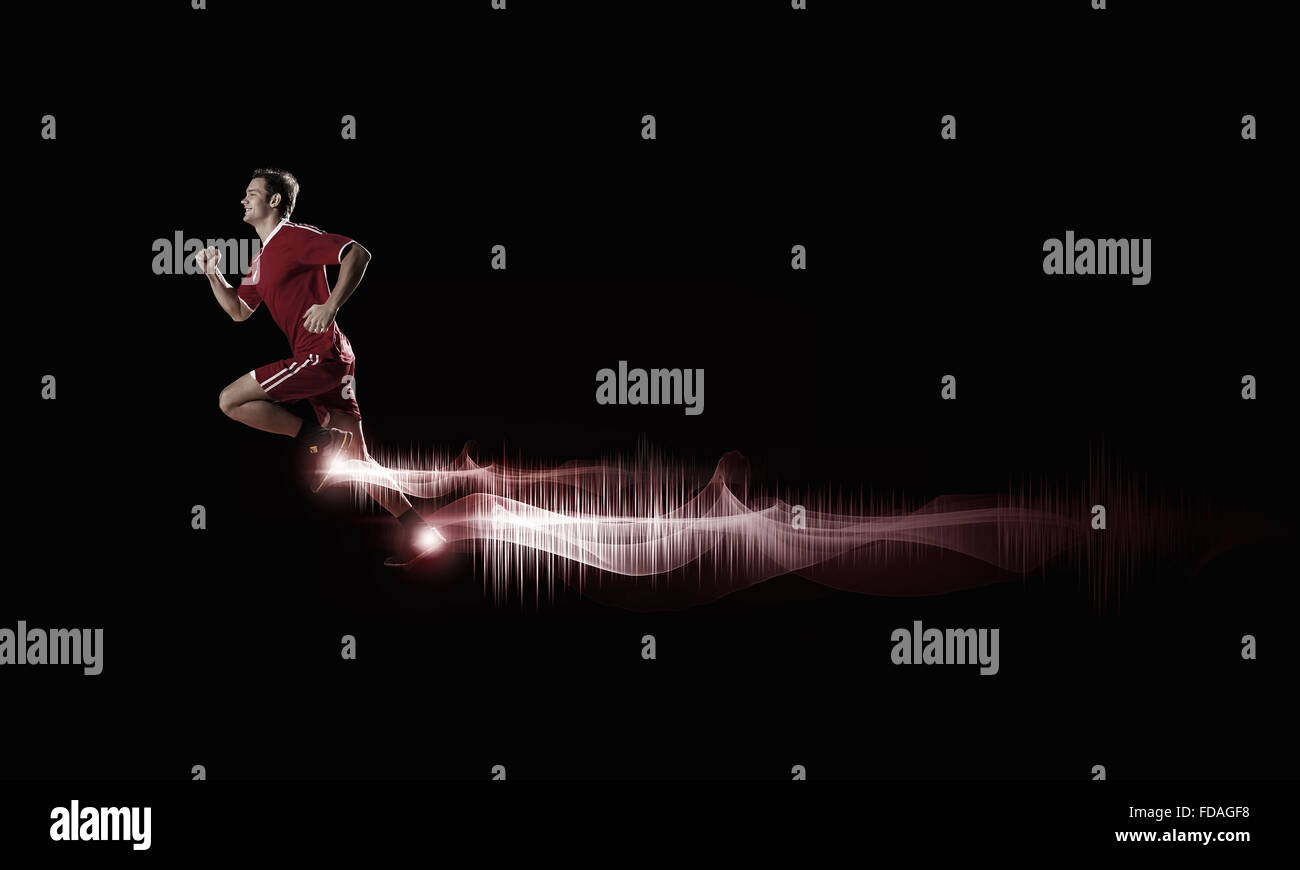 Running man in red sport wear on dark background Stock Photo - Alamy