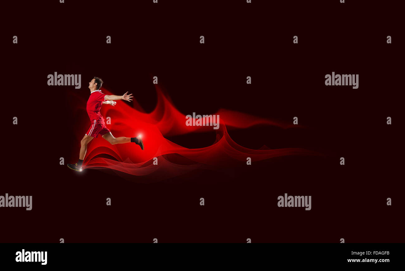 Running man in red sport wear on red background Stock Photo - Alamy
