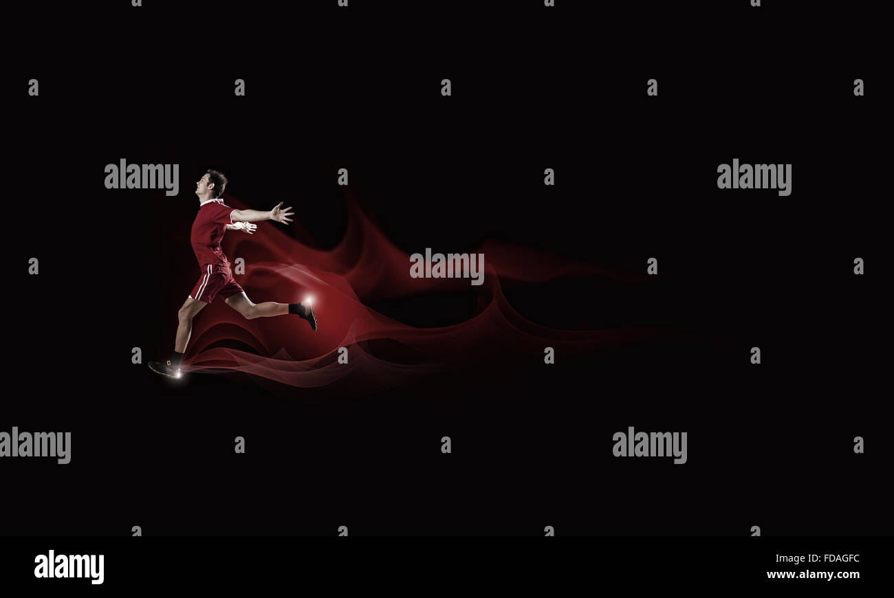 Running man in red sport wear on dark background Stock Photo - Alamy